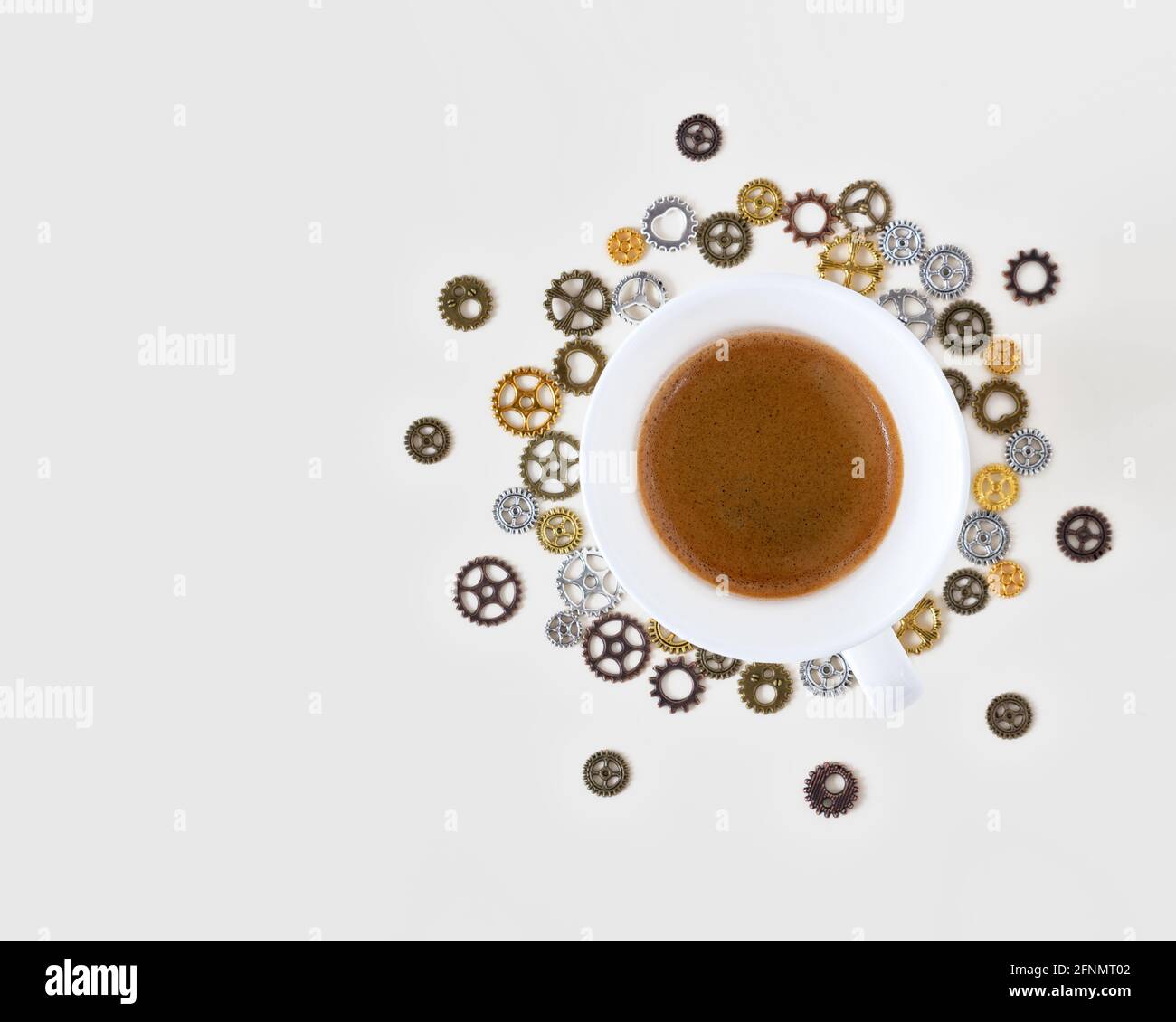 Coffee composition with a cup of freshly brewed espresso around gears ...