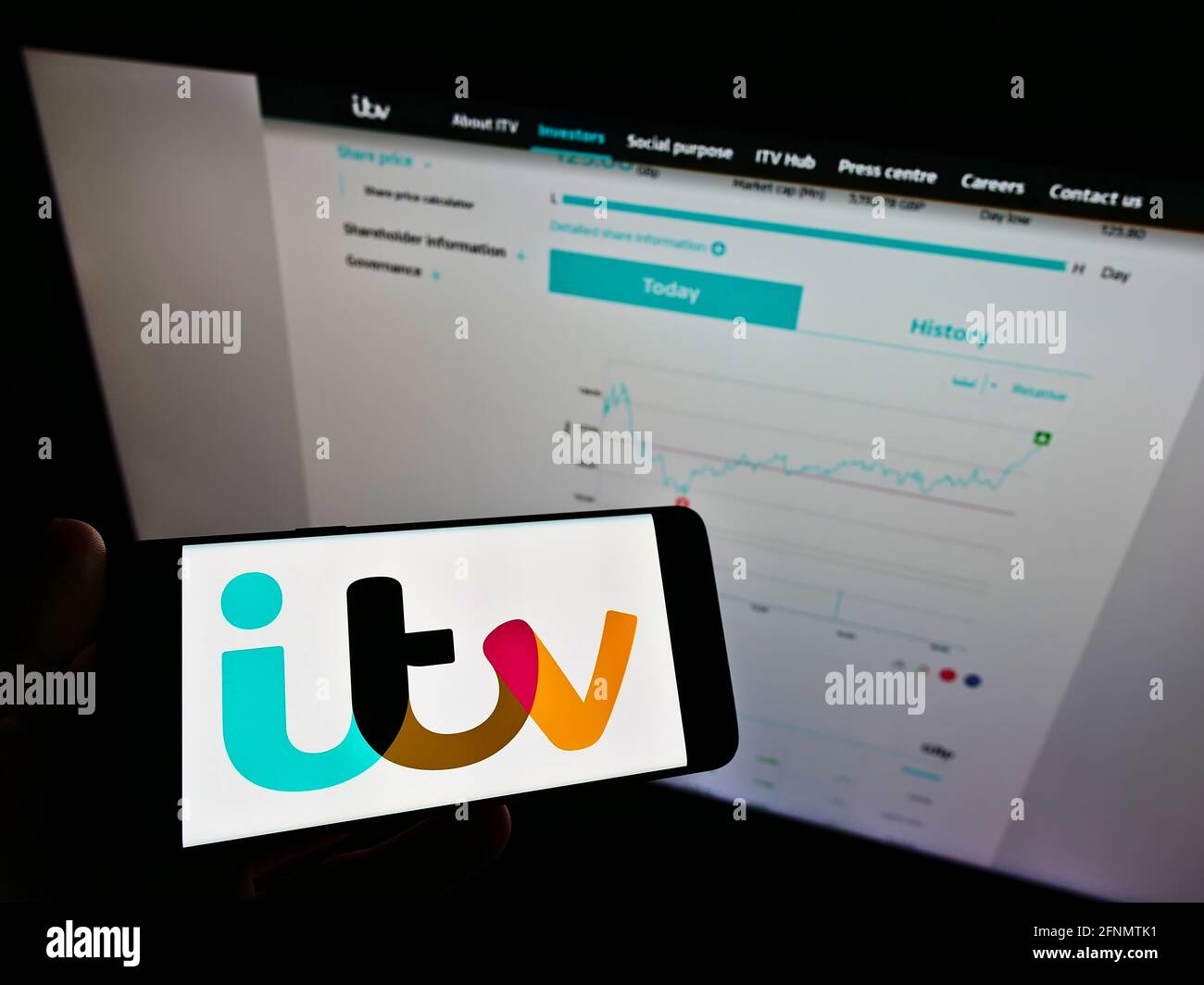 Person holding mobile phone with logo of British media company ITV plc ...