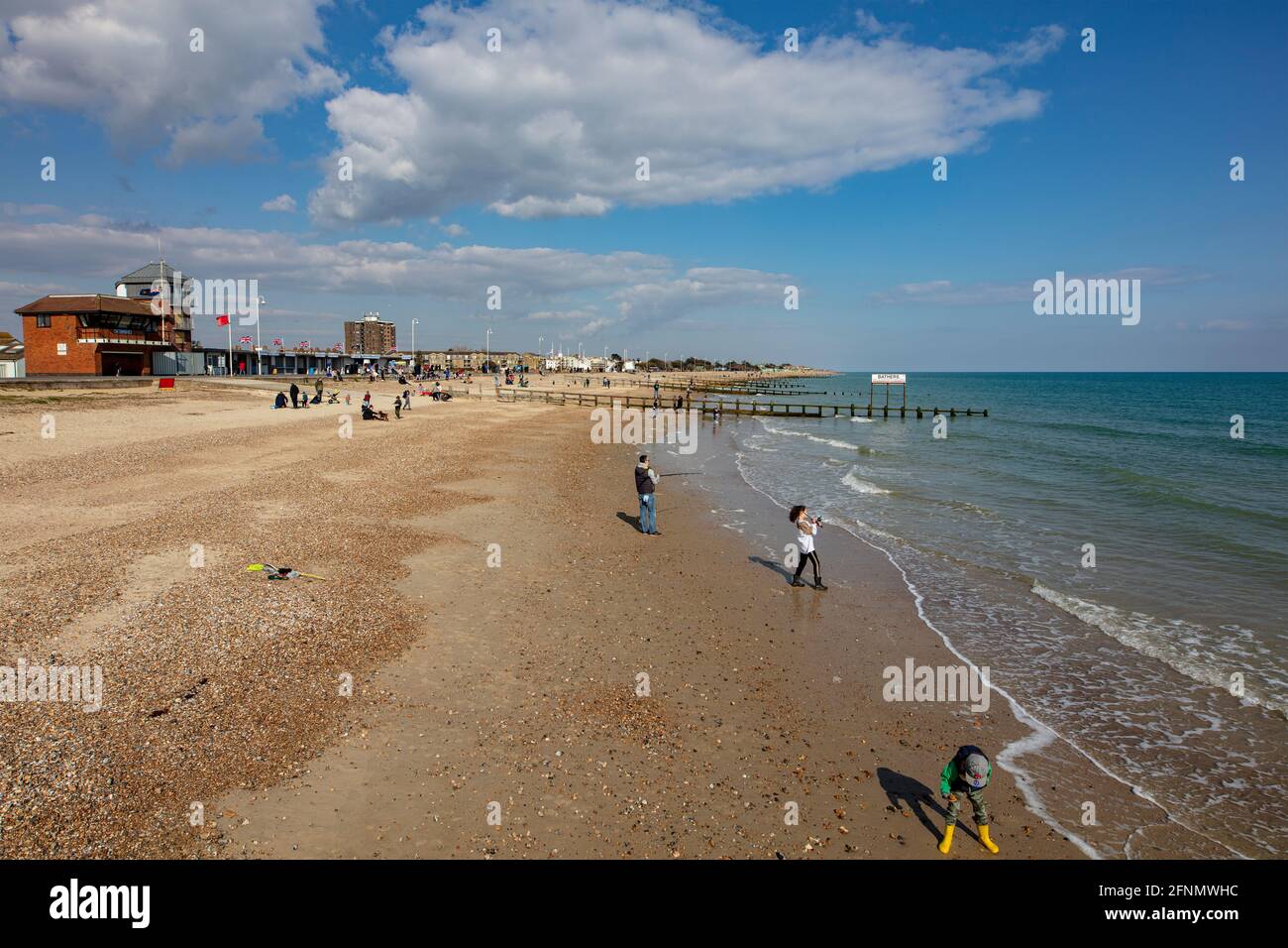 The beach at Littlehampton, West Sussex, UK; people fishing and playing ...