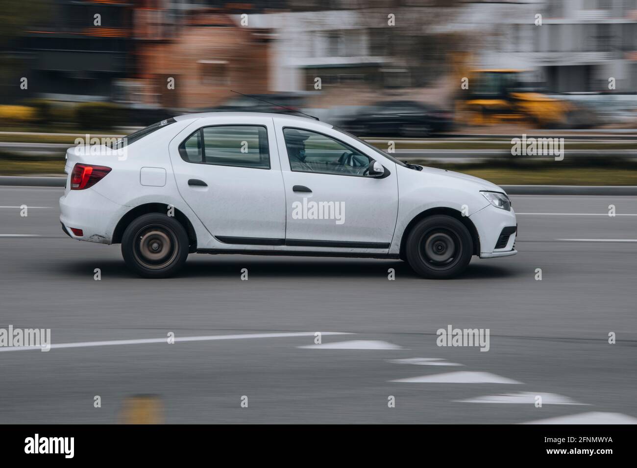Ukraine, Kyiv - 26 April 2021: White Renault Logan car moving on the ...
