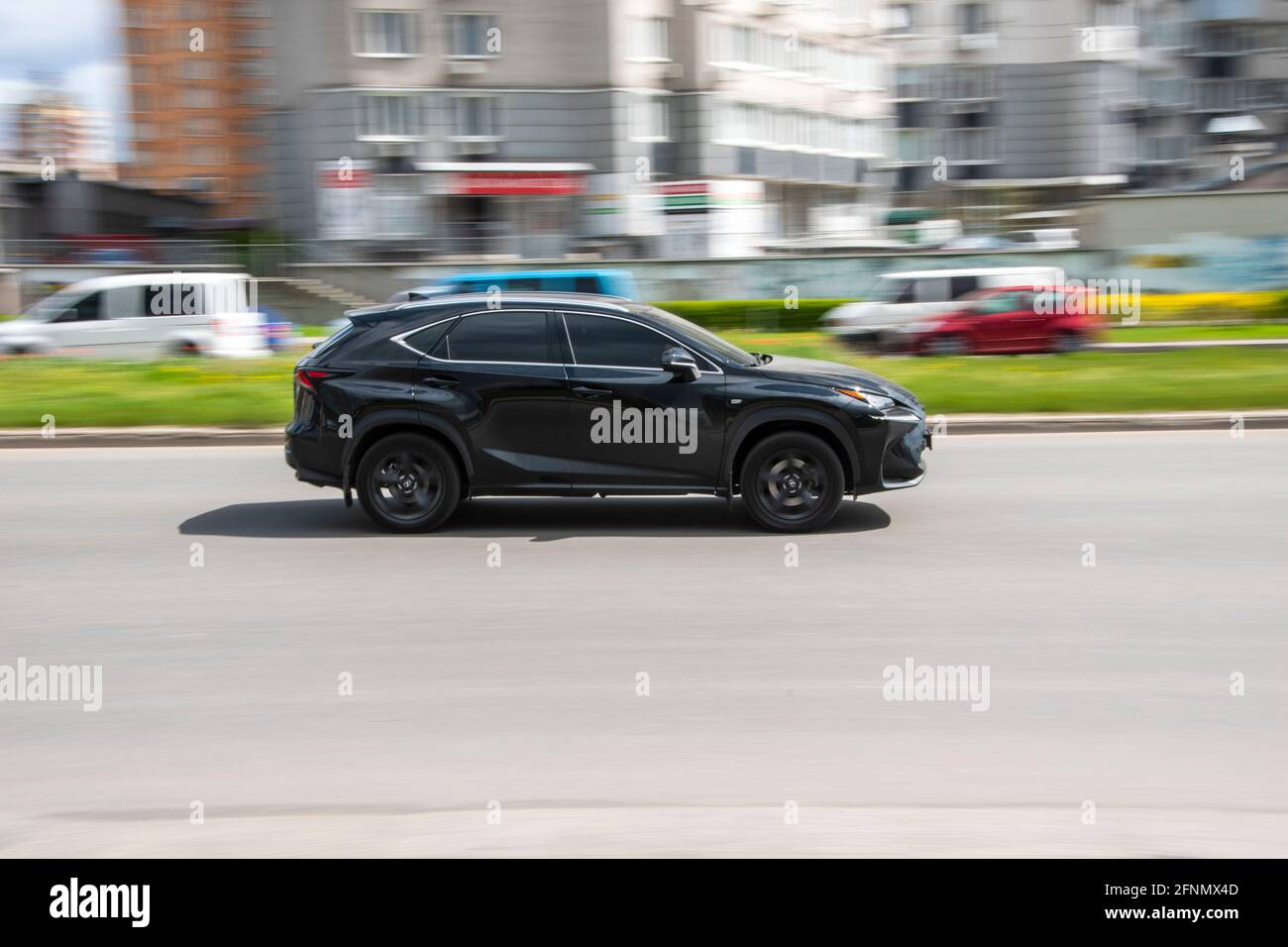 Ukraine, Kyiv - 26 April 2021: Black Lexus NX car moving on the street ...
