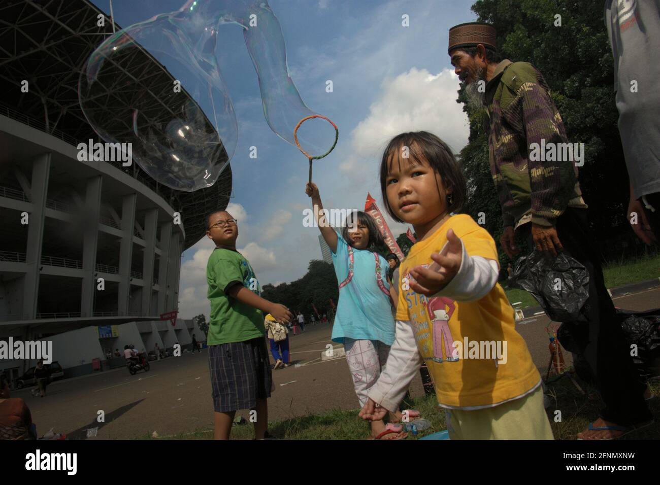 Children playing soap bubbles outside Main Stadium in Senayan Sports ...