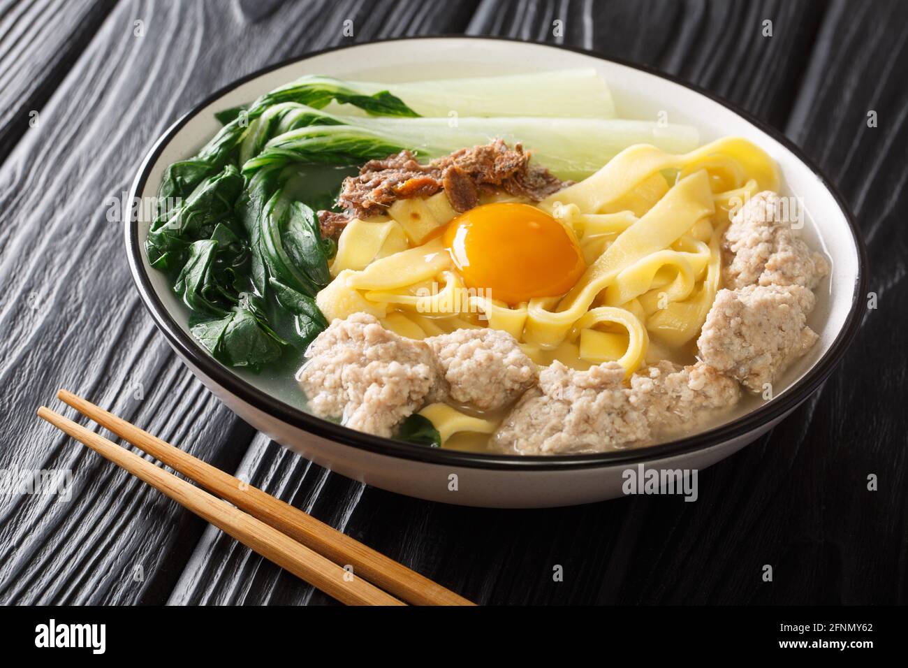 Delicious Asian homemade noodle soup with fried anchovies, meatballs ...
