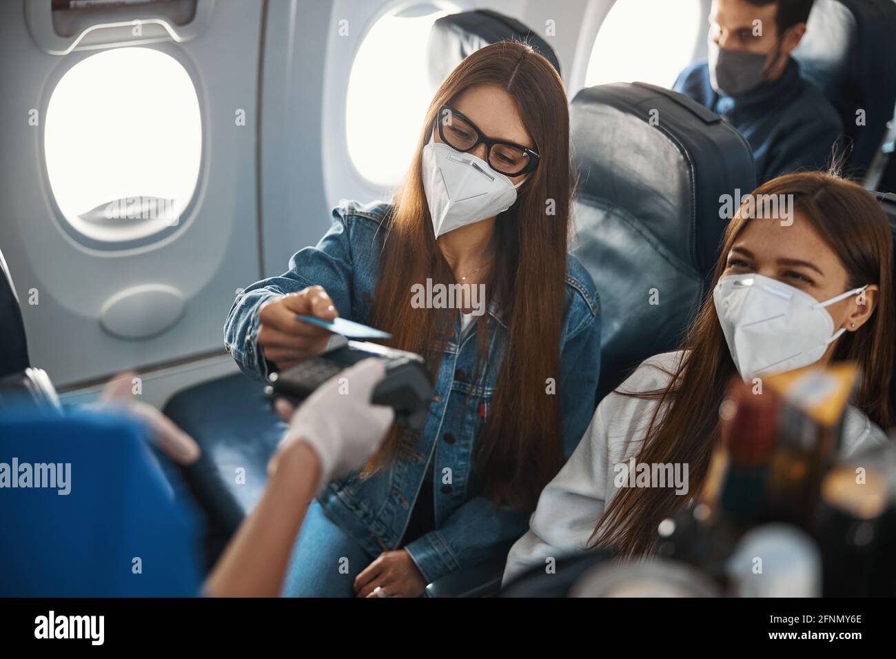 Young plane passenger using bank card for payment on terminal Stock ...