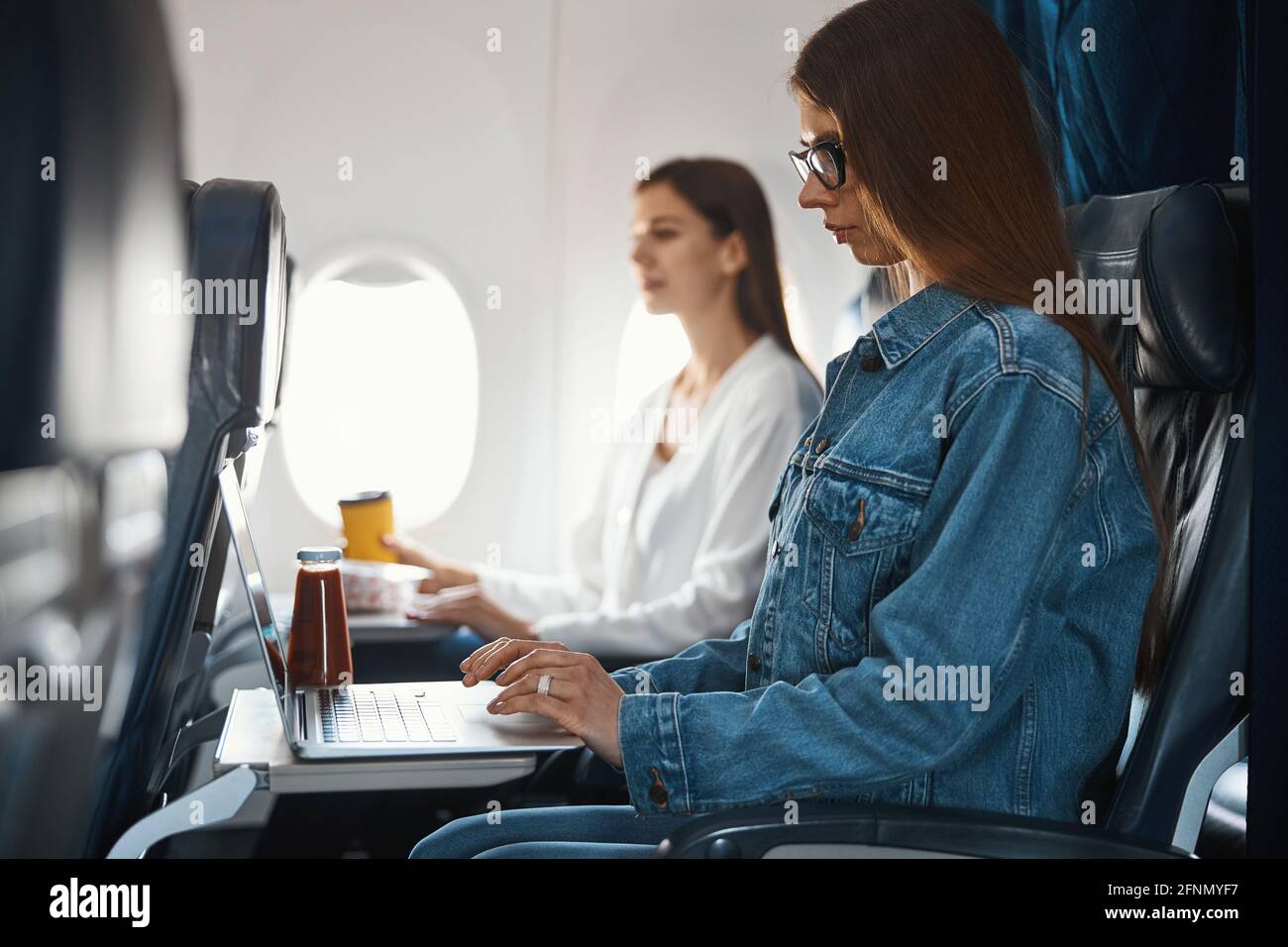 Woman holding plane seat hi-res stock photography and images - Alamy