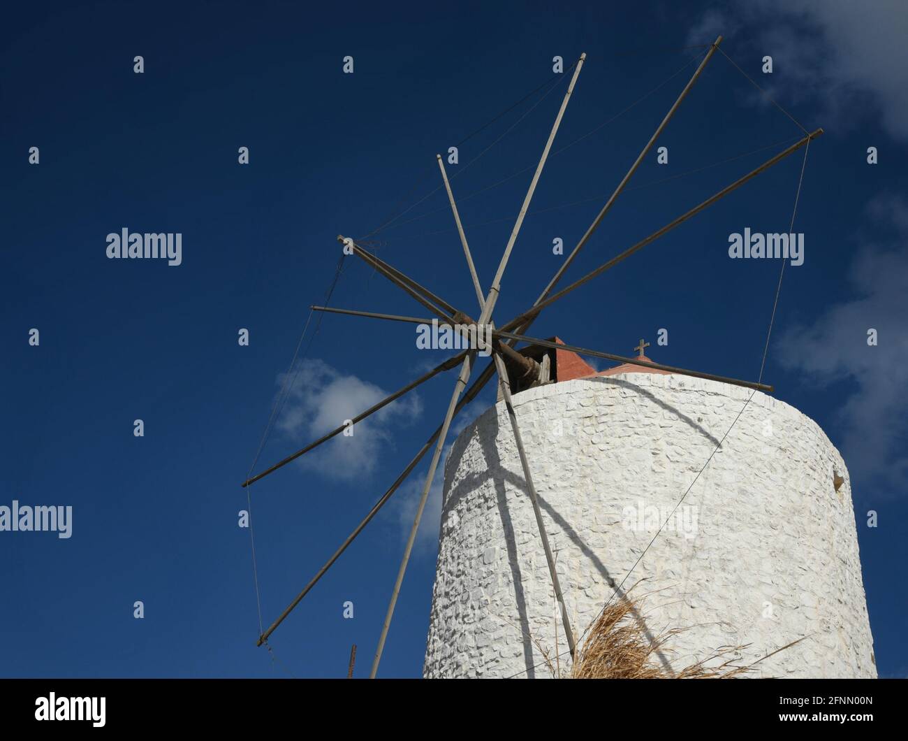 Scenic landscape with an old traditional whitewashed stone windmill in ...