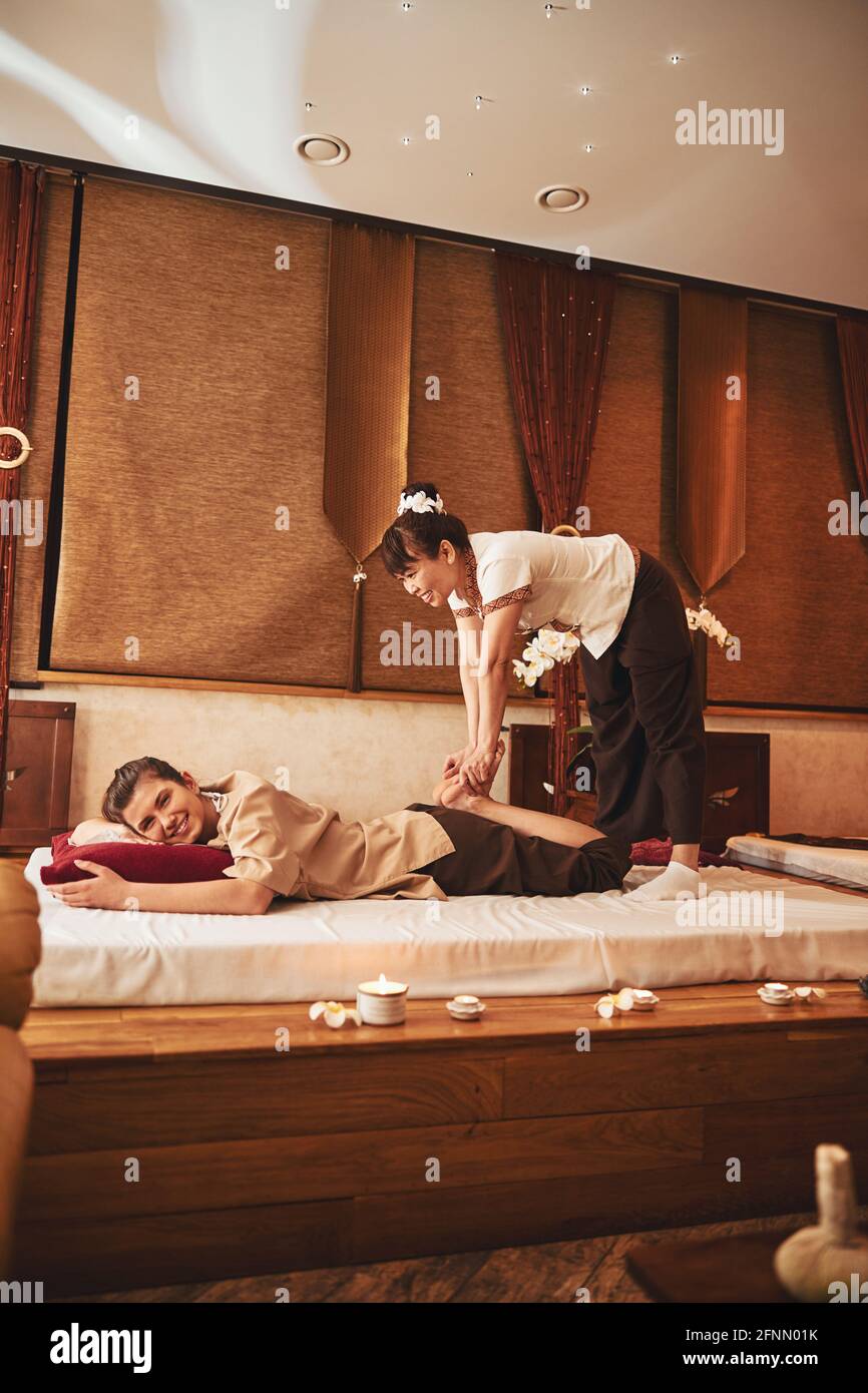 Worker of spa centre and client during feet massage Stock Photo - Alamy