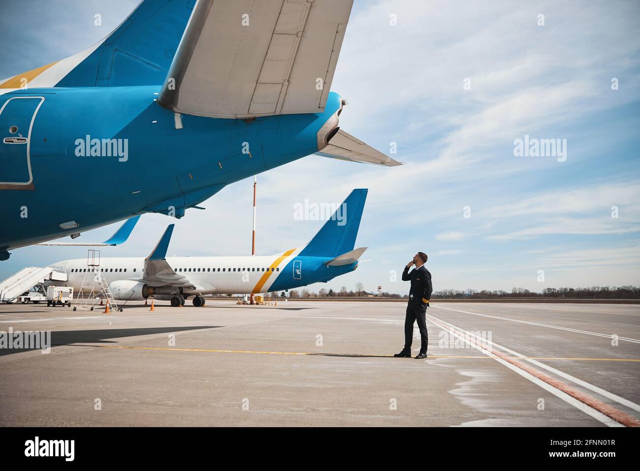 Pilot checking rear part of plane before flight Stock Photo - Alamy