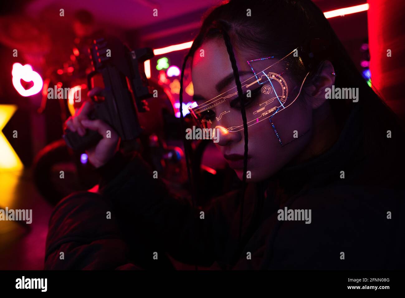 armed asian woman in sunglasses holding blurred gun outside Stock Photo ...