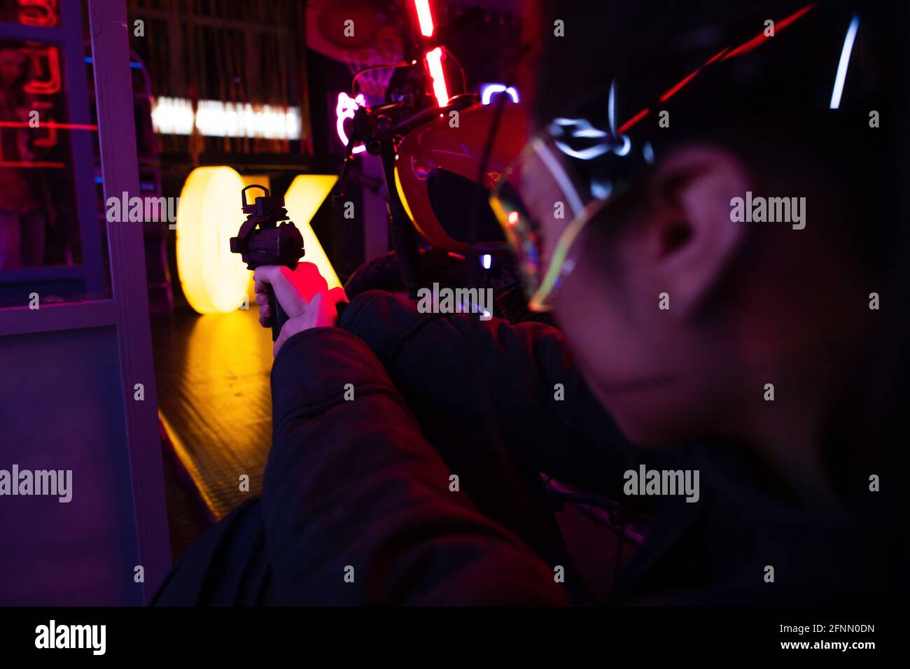 blurred asian woman aiming with gun outside Stock Photo - Alamy