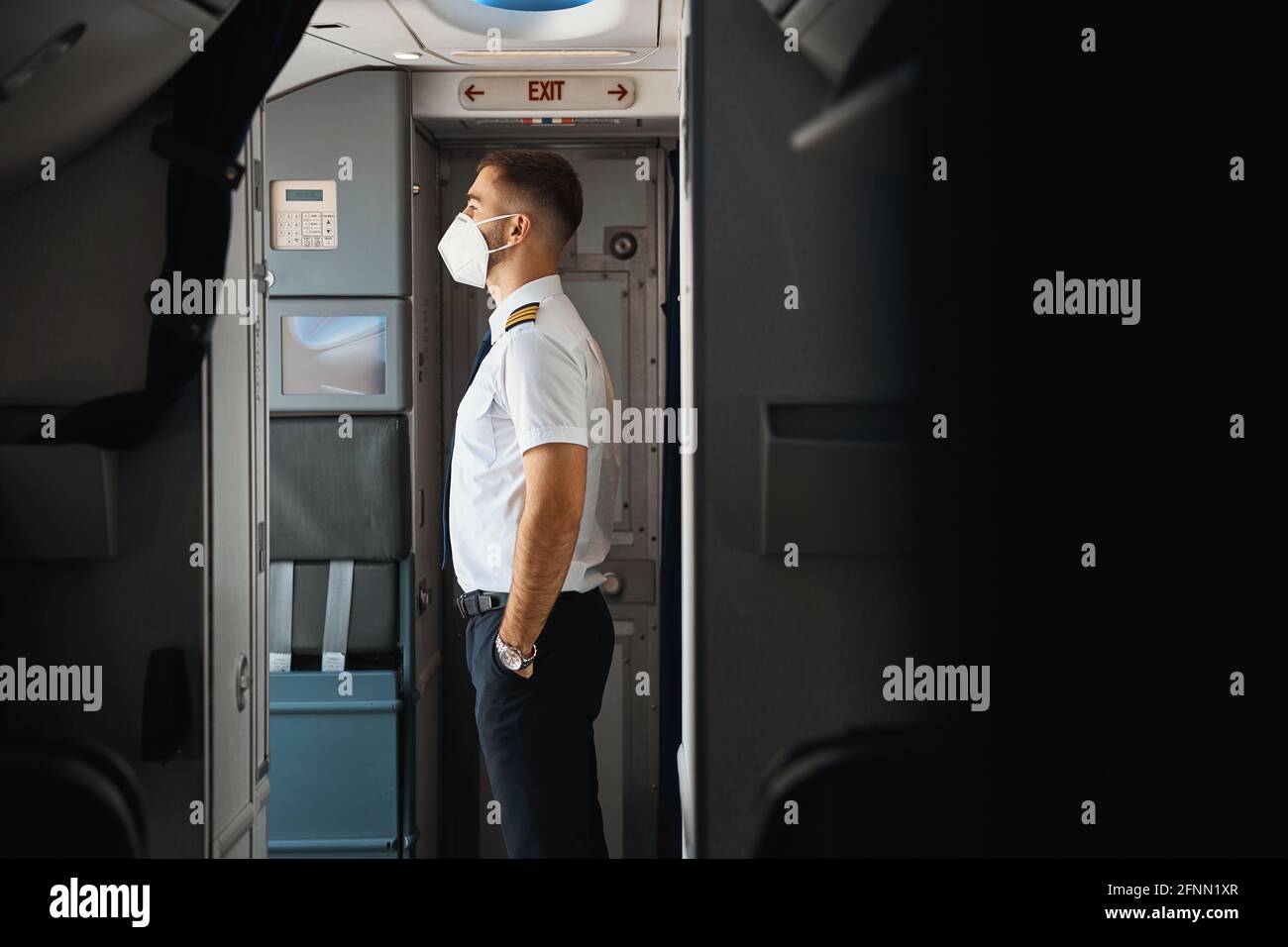 Airman in uniform standing under the exit sign Stock Photo - Alamy