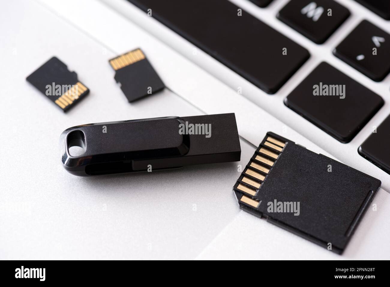 Multiple storage devices, pendrive, memory cards on laptop Stock Photo ...