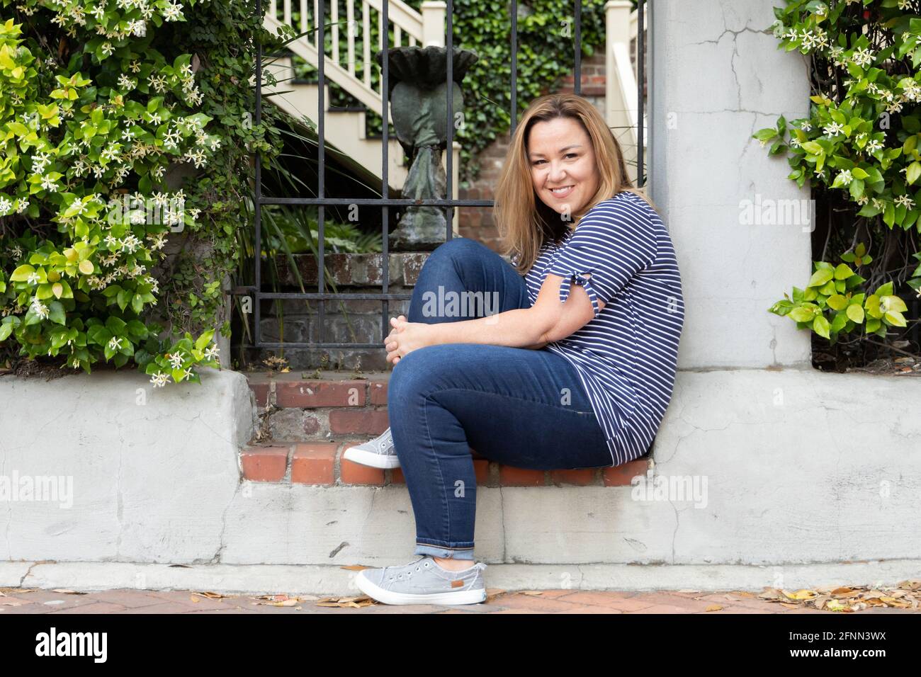 a single woman in her 40's sitting outside as a tourist in Savannah ...