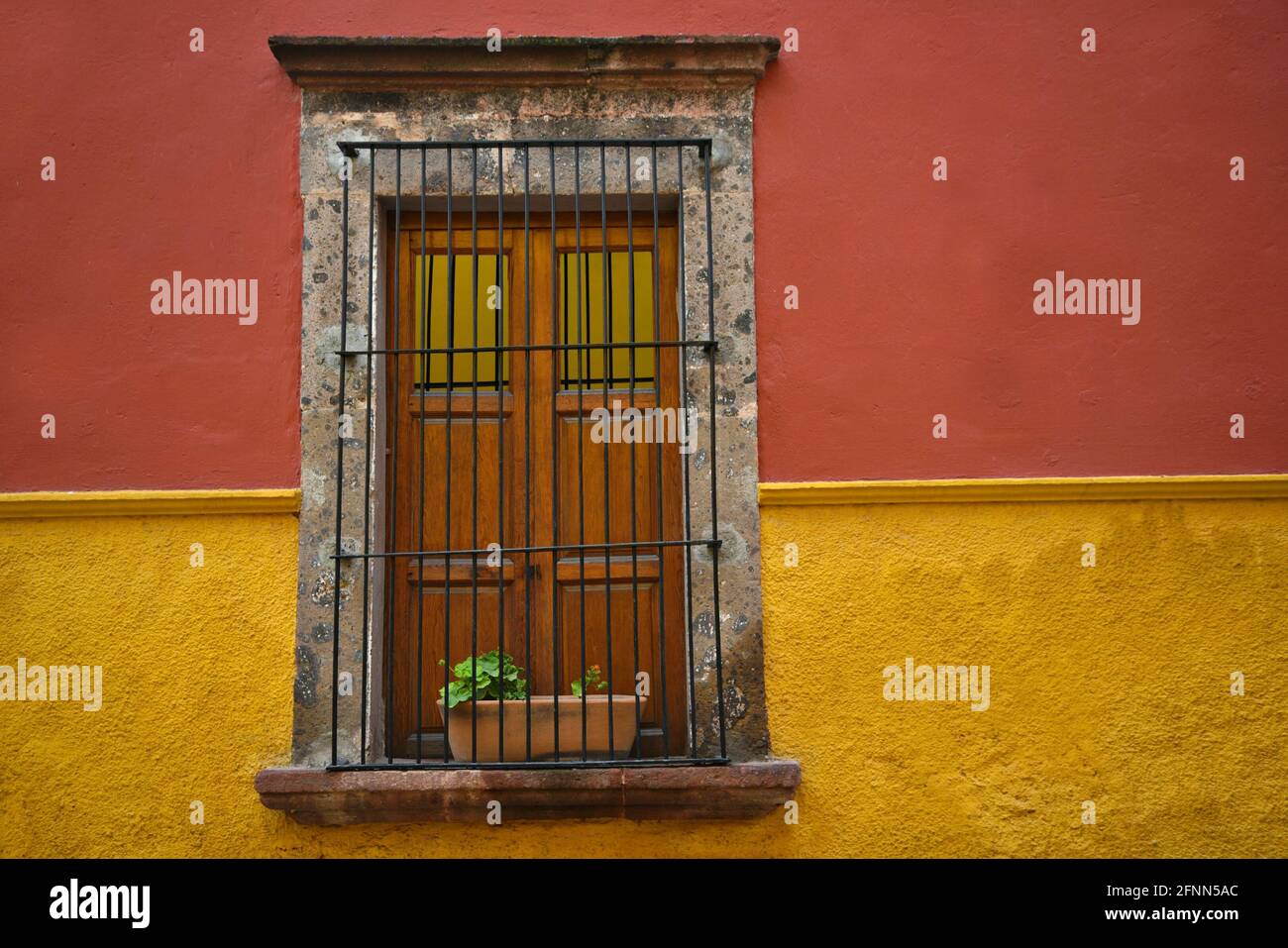 Old Colonial building window with stone trim and handcrafted iron ...