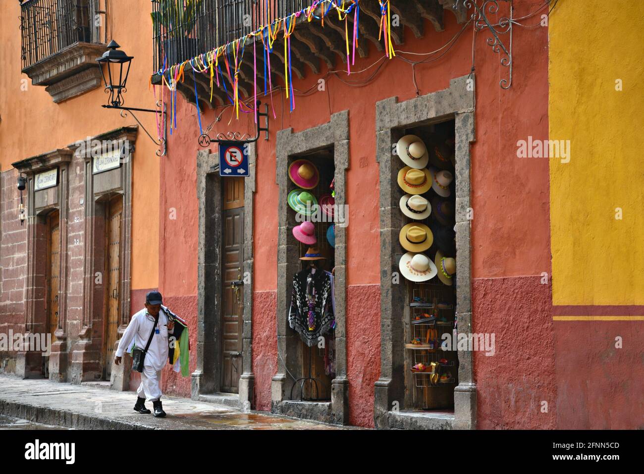 Indigenous man walking on the cobblestone streets of San Miguel de ...