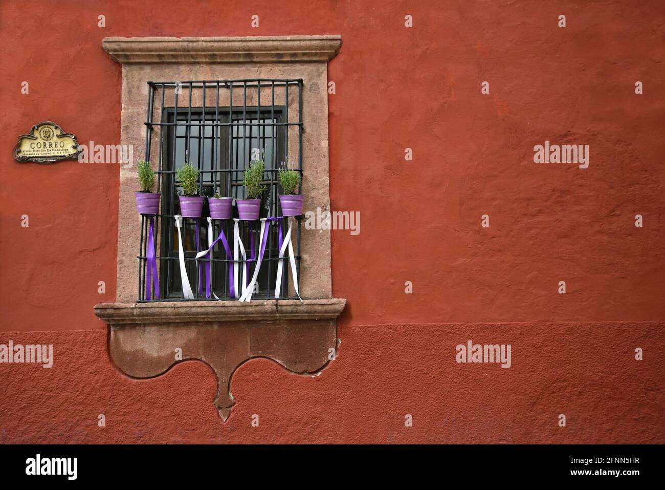 Colonial house window with handcrafted iron grilles, clay pots and ...