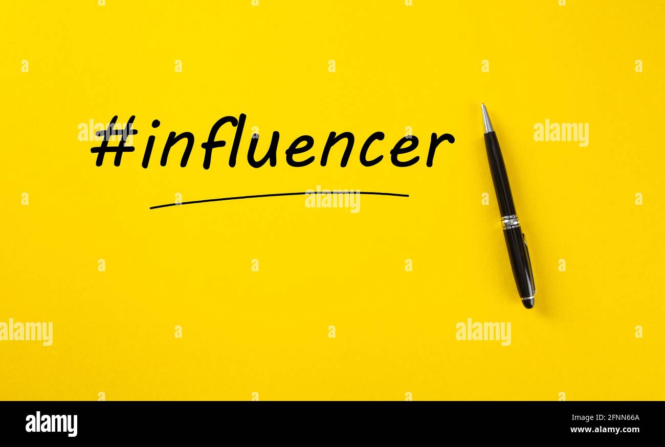 Hand written influencer word with hashtag symbol and a pen marker on ...