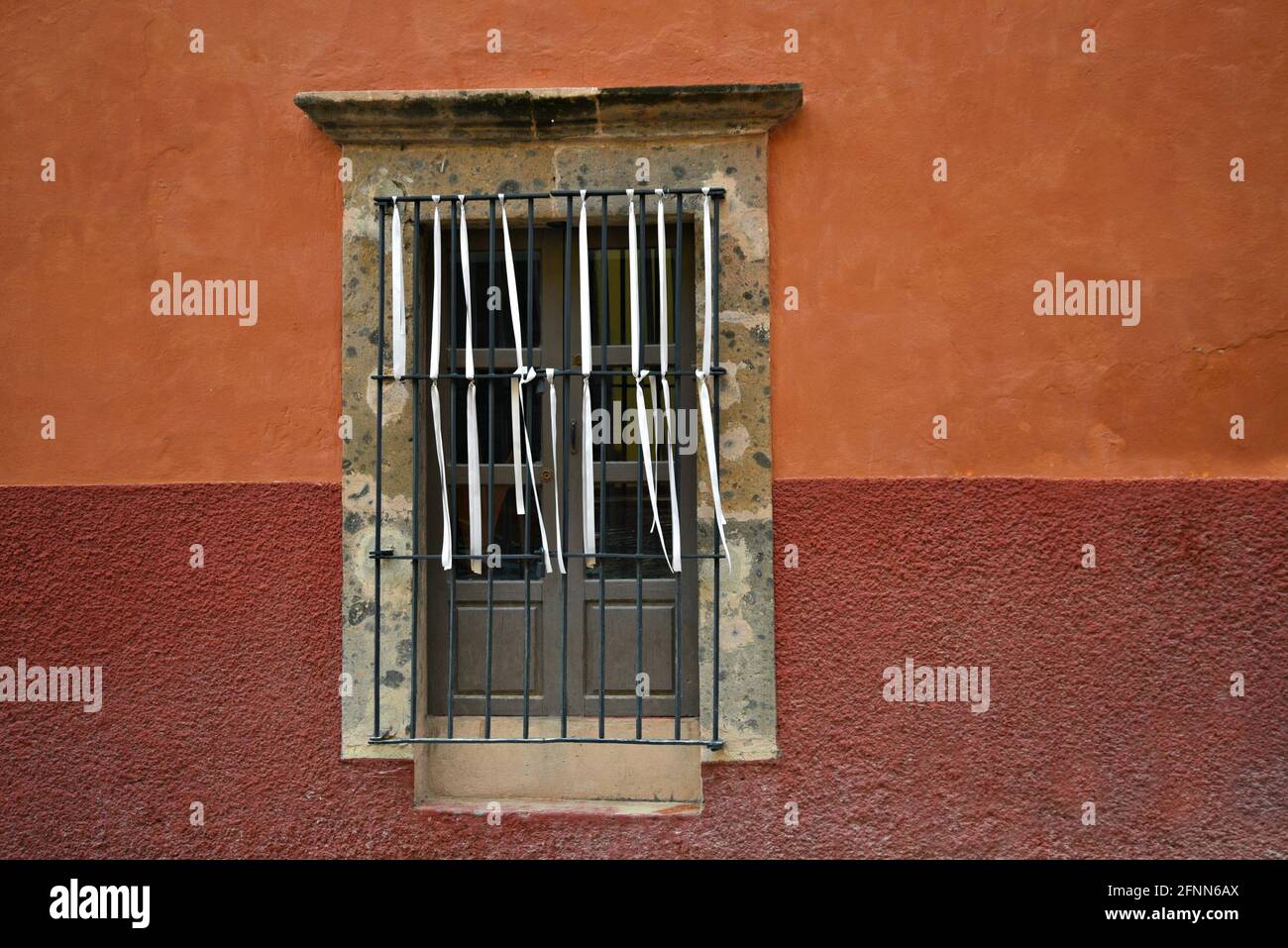 Colonial house window with stone trim, handcrafted iron grilles and ...