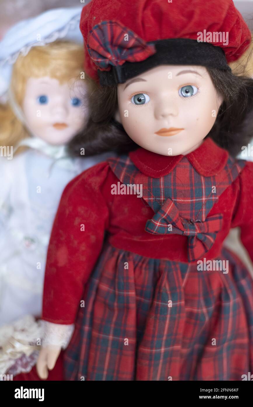 Vertical shot of beautiful porcelain dolls dressed in traditional ...
