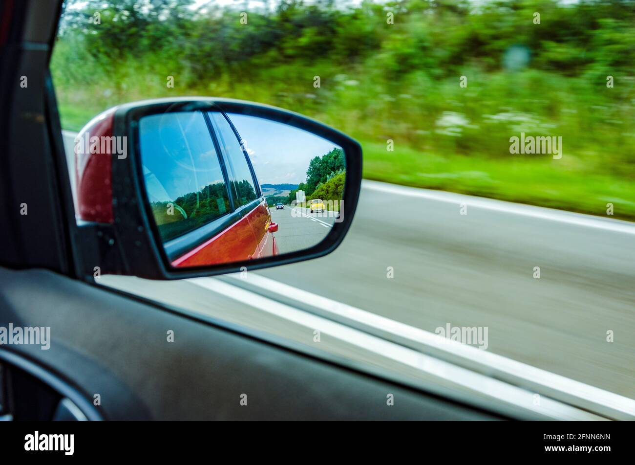 Reflection of blurred cars in the rear view mirror on highway Stock ...