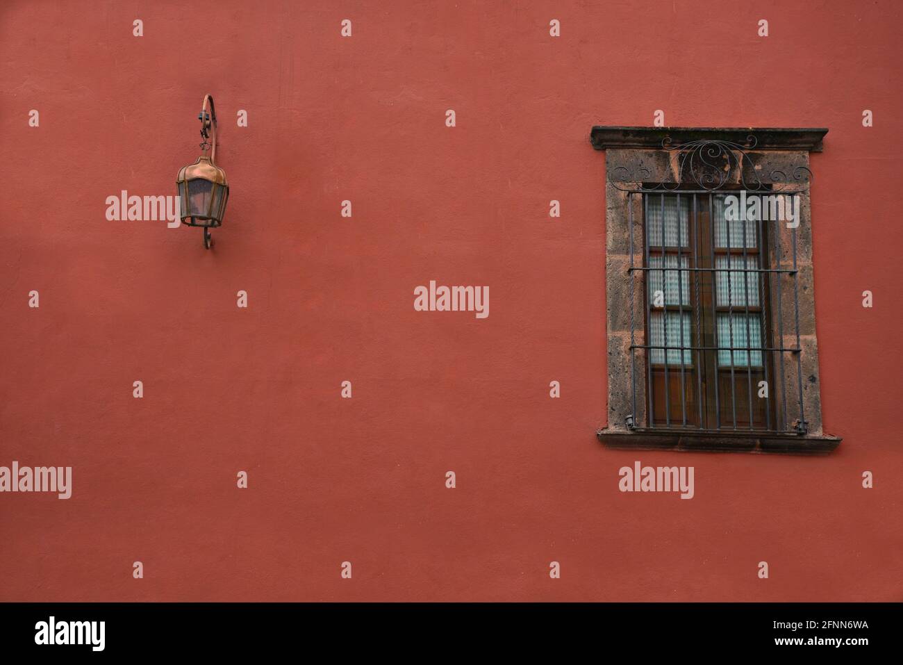 Colonial house window with stone trim and an antique cast iron wall ...