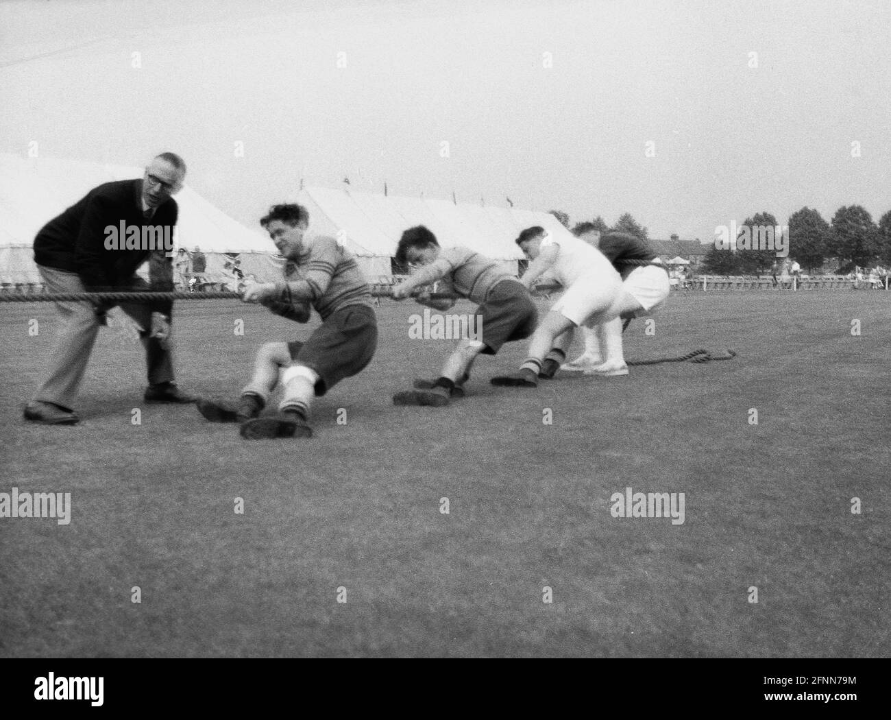 1954, historical, outside in a field, at a civil service sports day, in ...