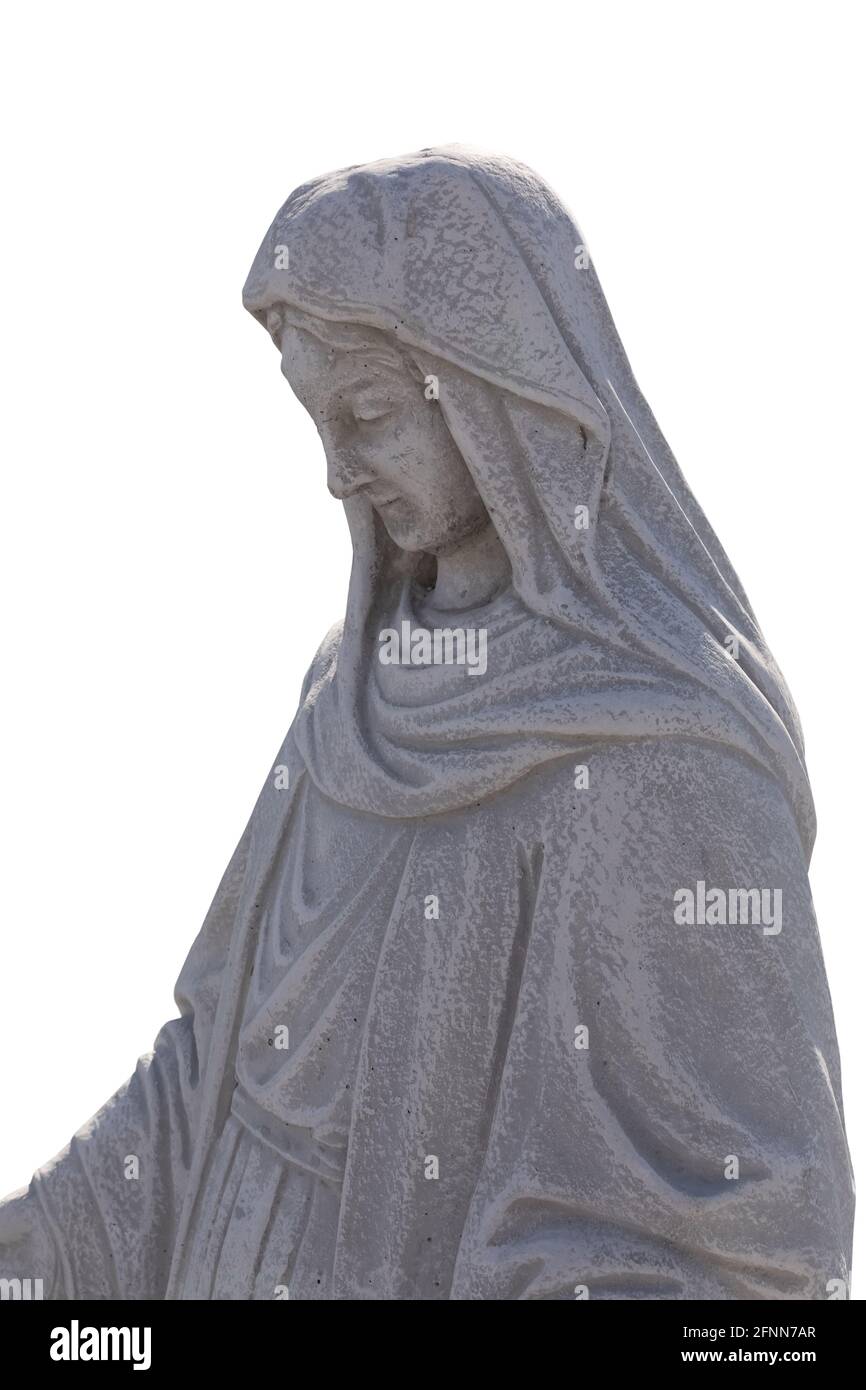 Close up side view of stone sculpture of virgin mary on white ...