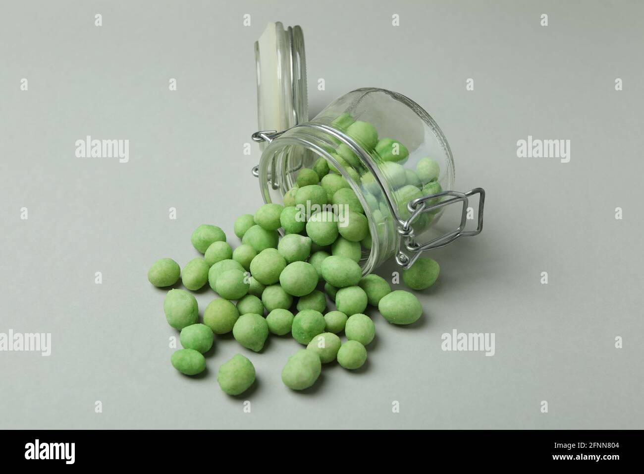 Glass jar with wasabi nuts on gray background Stock Photo - Alamy