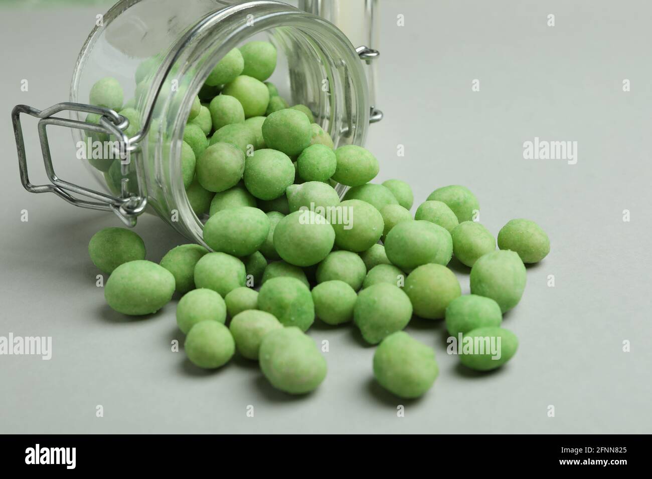Glass jar with wasabi nuts on gray background Stock Photo - Alamy
