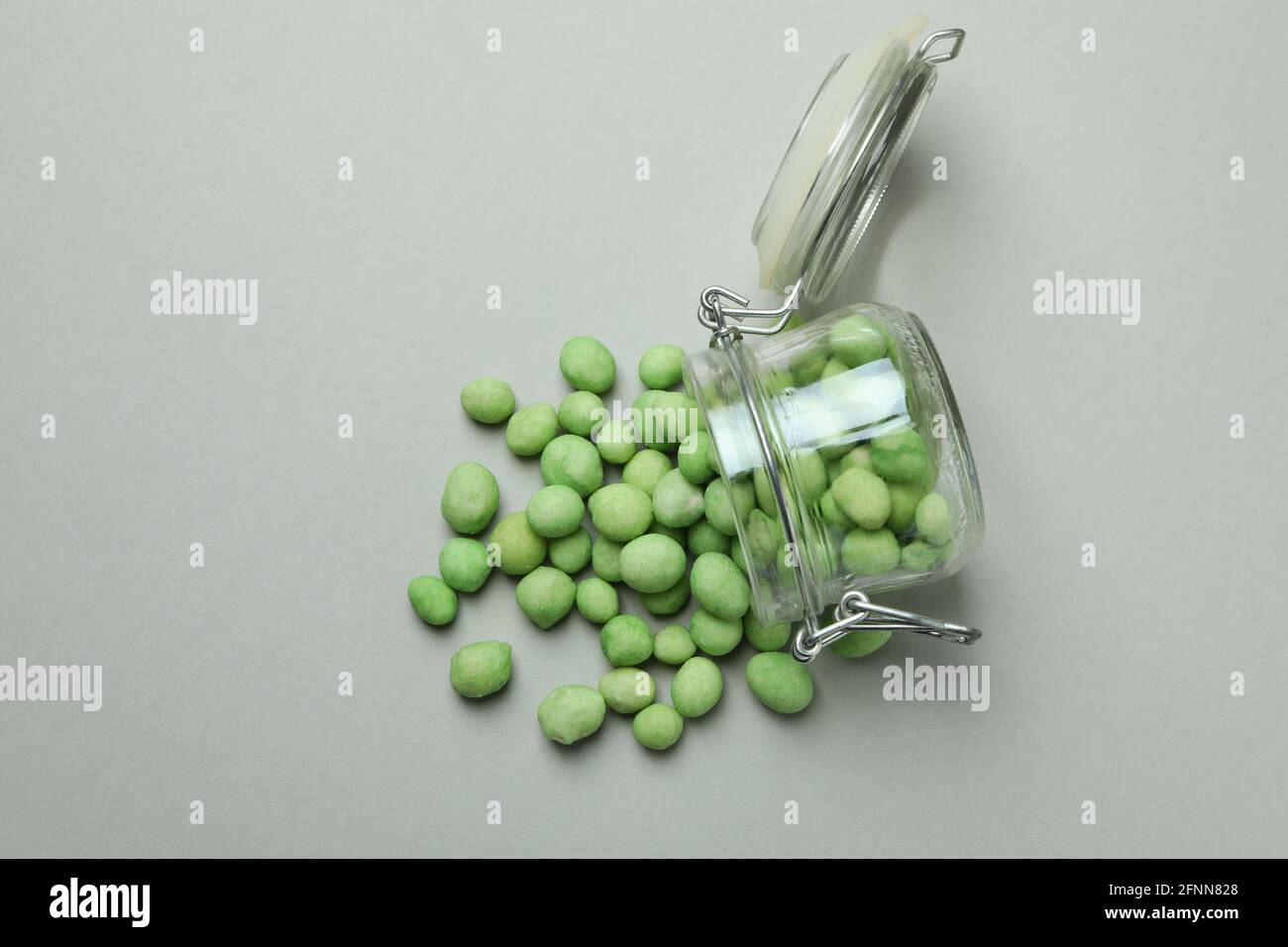Glass jar with wasabi nuts on gray background Stock Photo - Alamy
