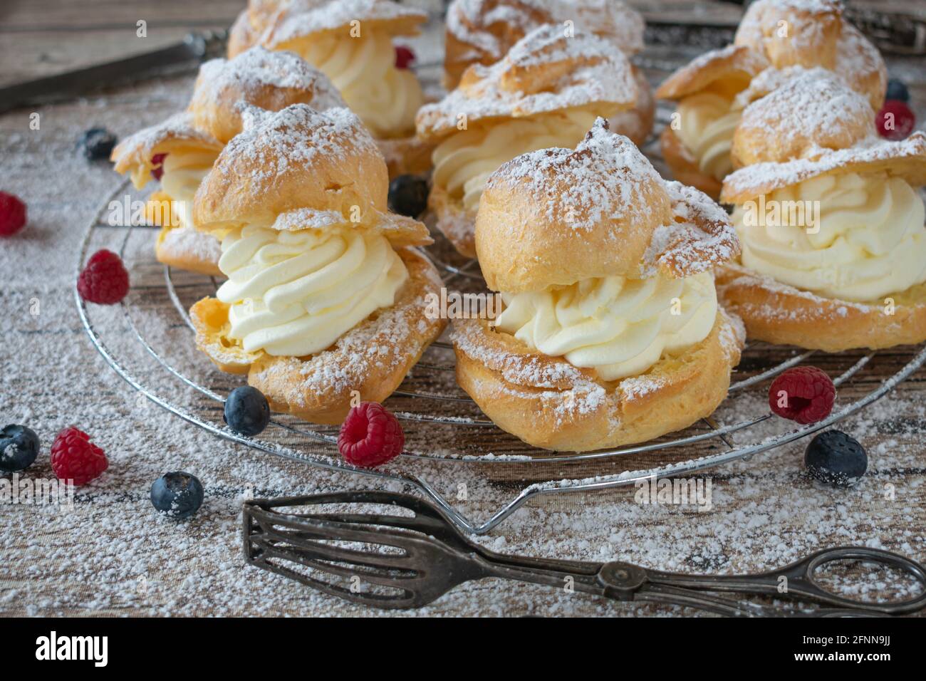 Fresh baked cream puffs on a cooling rack Stock Photo - Alamy