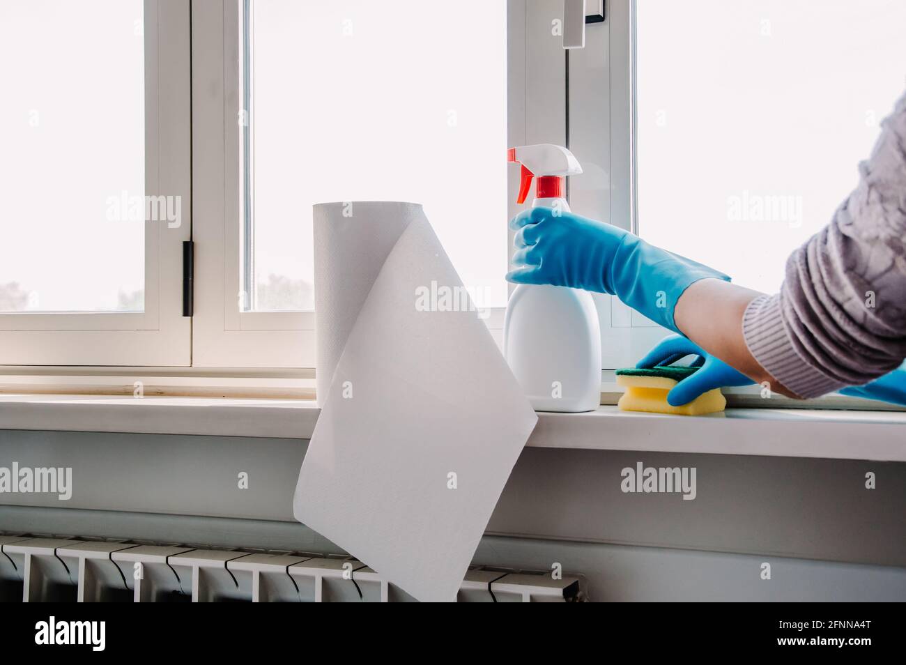 A set for cleaning windows. Hand in a blue glove. Cleaning tools and ...