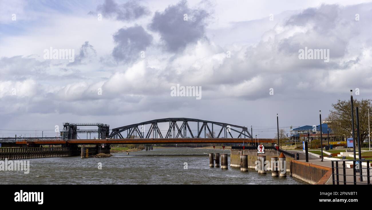Dramatic sky over river IJssel with steel draw bridge Stock Photo - Alamy