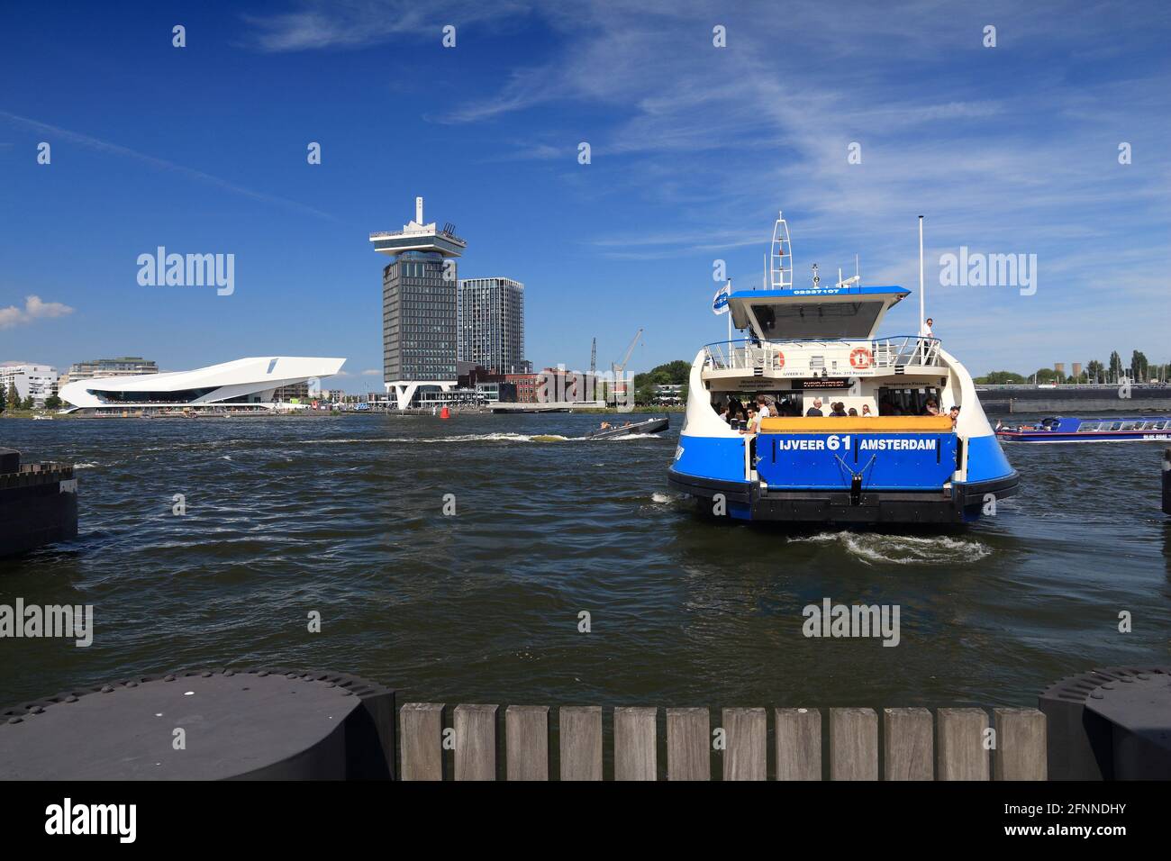AMSTERDAM, NETHERLANDS - JULY 9, 2017: People ride the ferry to cross ...