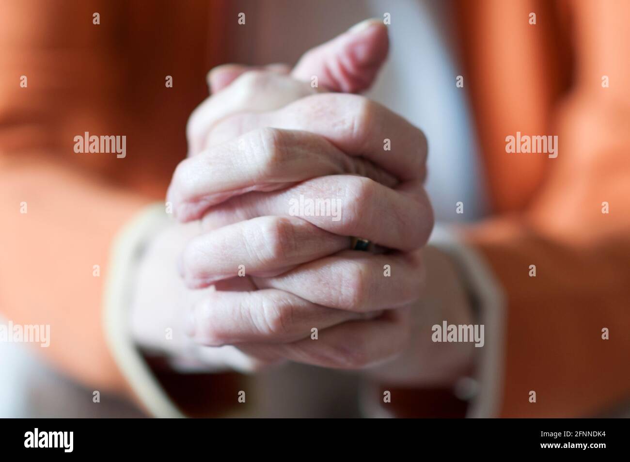 Old woman holding hands clasped in prayer Stock Photo - Alamy