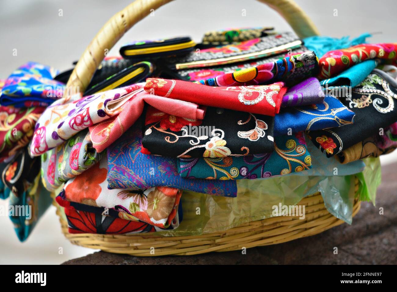 Authentic, artisan, handmade traditional silk scarves in a wicker ...