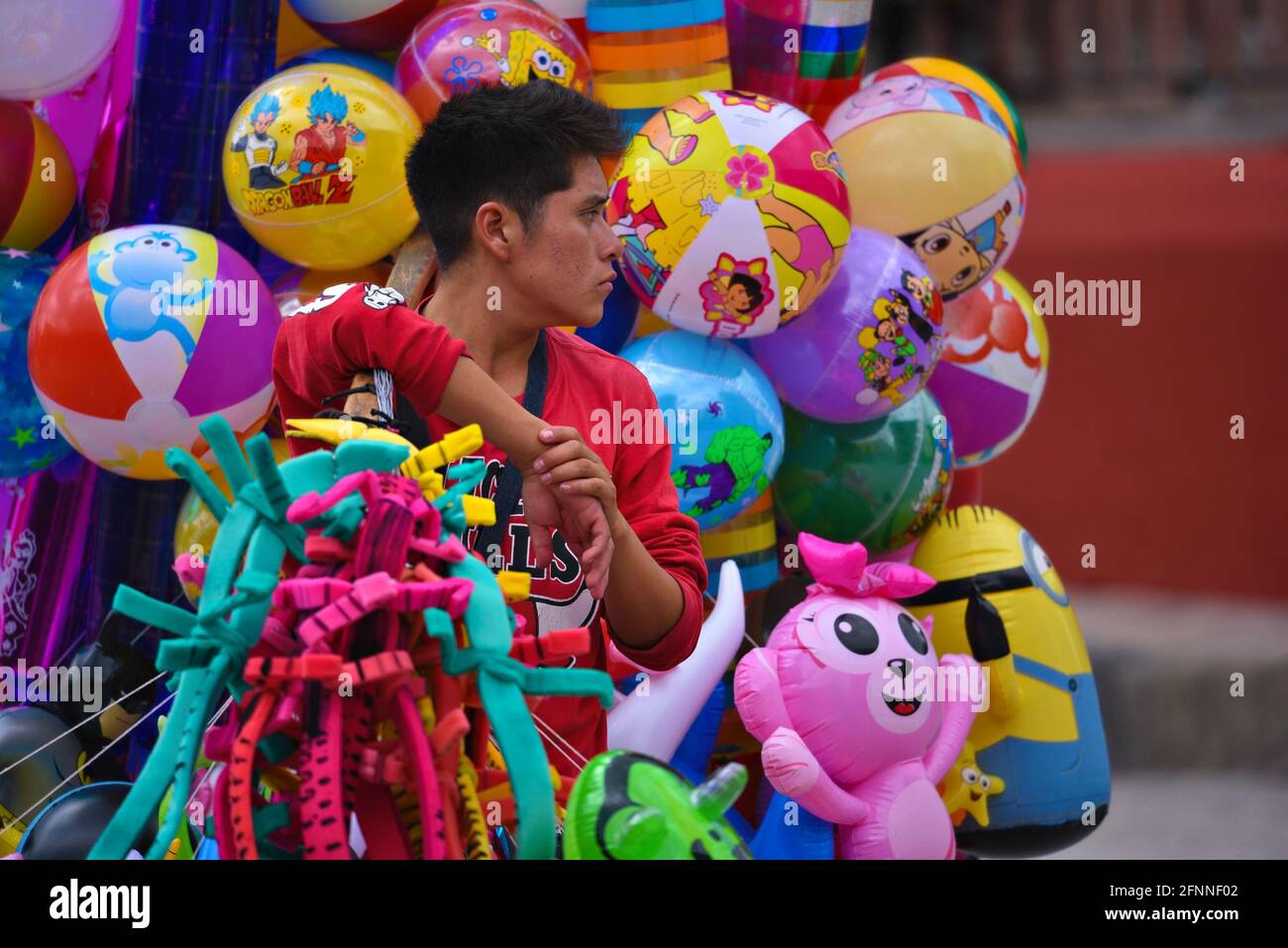 Colorful balloons vendor on the cobblestone streets of San Miguel de ...