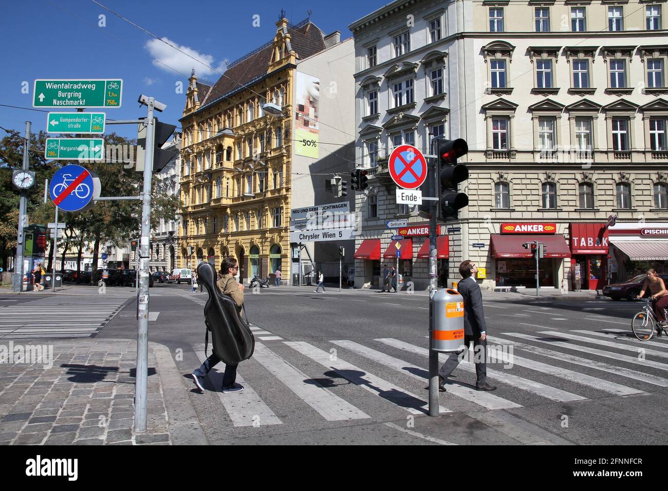 VIENNA, AUSTRIA - SEPTEMBER 6, 2011: Pedestrians cross a street in ...