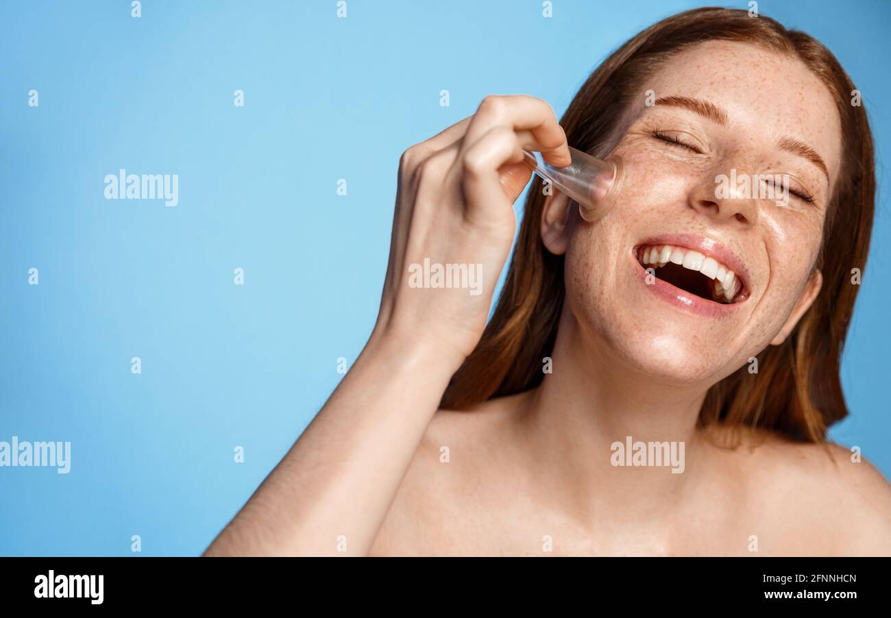 Skin care. Happy woman doing facial cupping massage at home, using ...