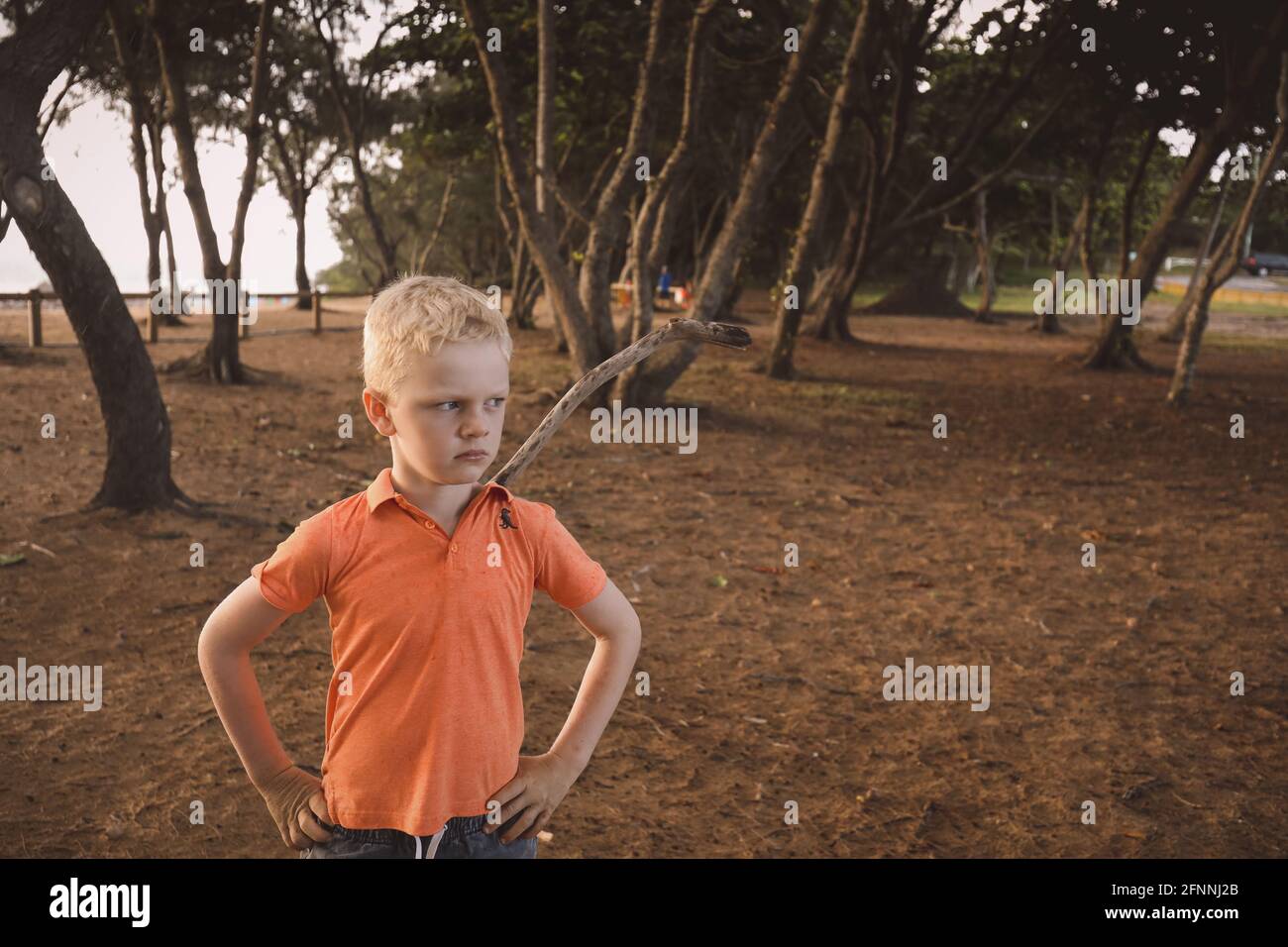 Closeup shot of a white Caucasian young boy staring with an angry face ...