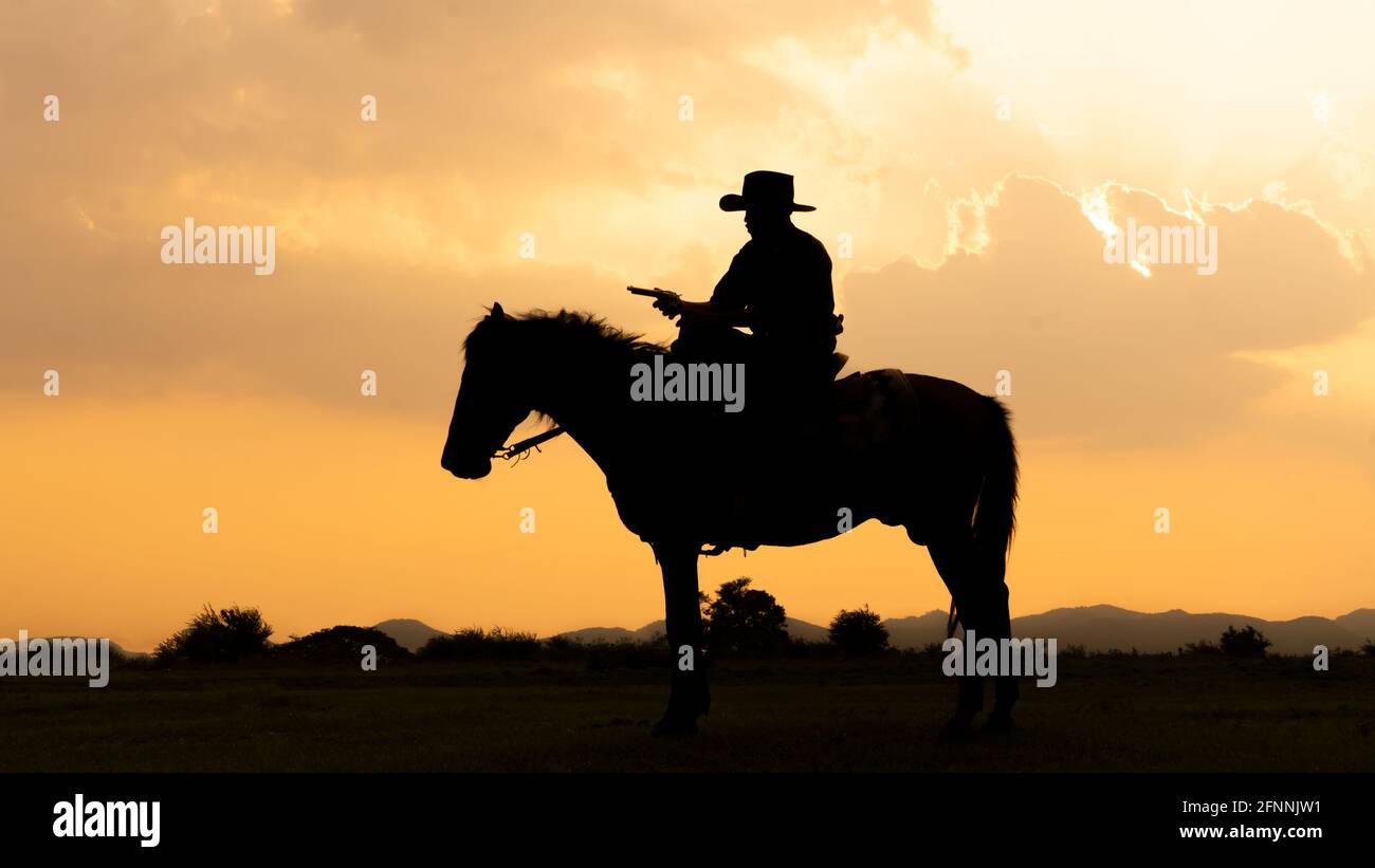 cowboy on horseback against a beautiful sunset, cowboy and horse at ...