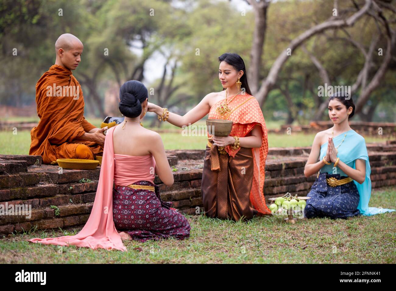 Women giving food to monk hi-res stock photography and images - Alamy