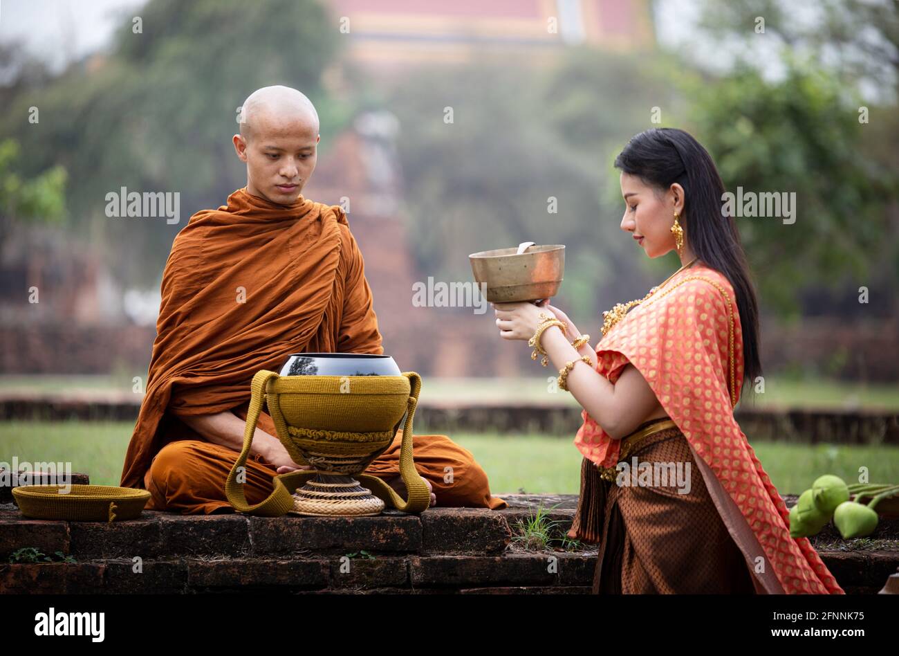 The women gave food to monks to monks Stock Photo - Alamy