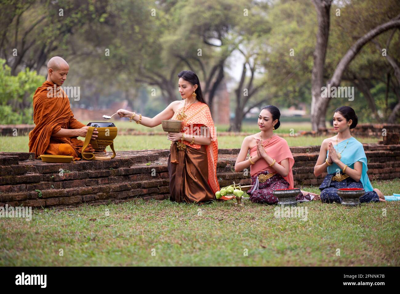The women gave food to monks to monks Stock Photo - Alamy