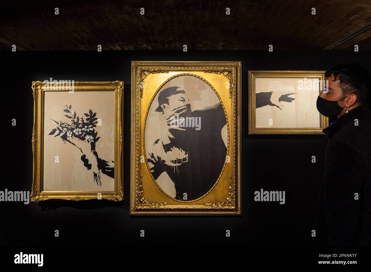 London, UK. 18 May 2021. A staff member poses with "GDP Flower Thrower ...