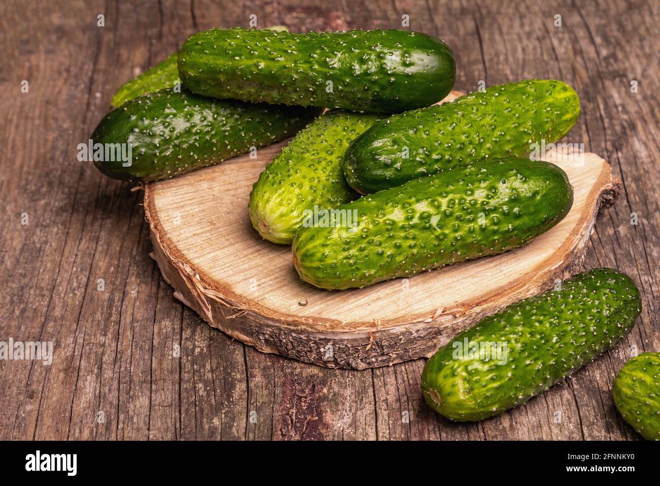 Crispy cucumbers on a wooden stand. Fresh green vegetables, organic ...