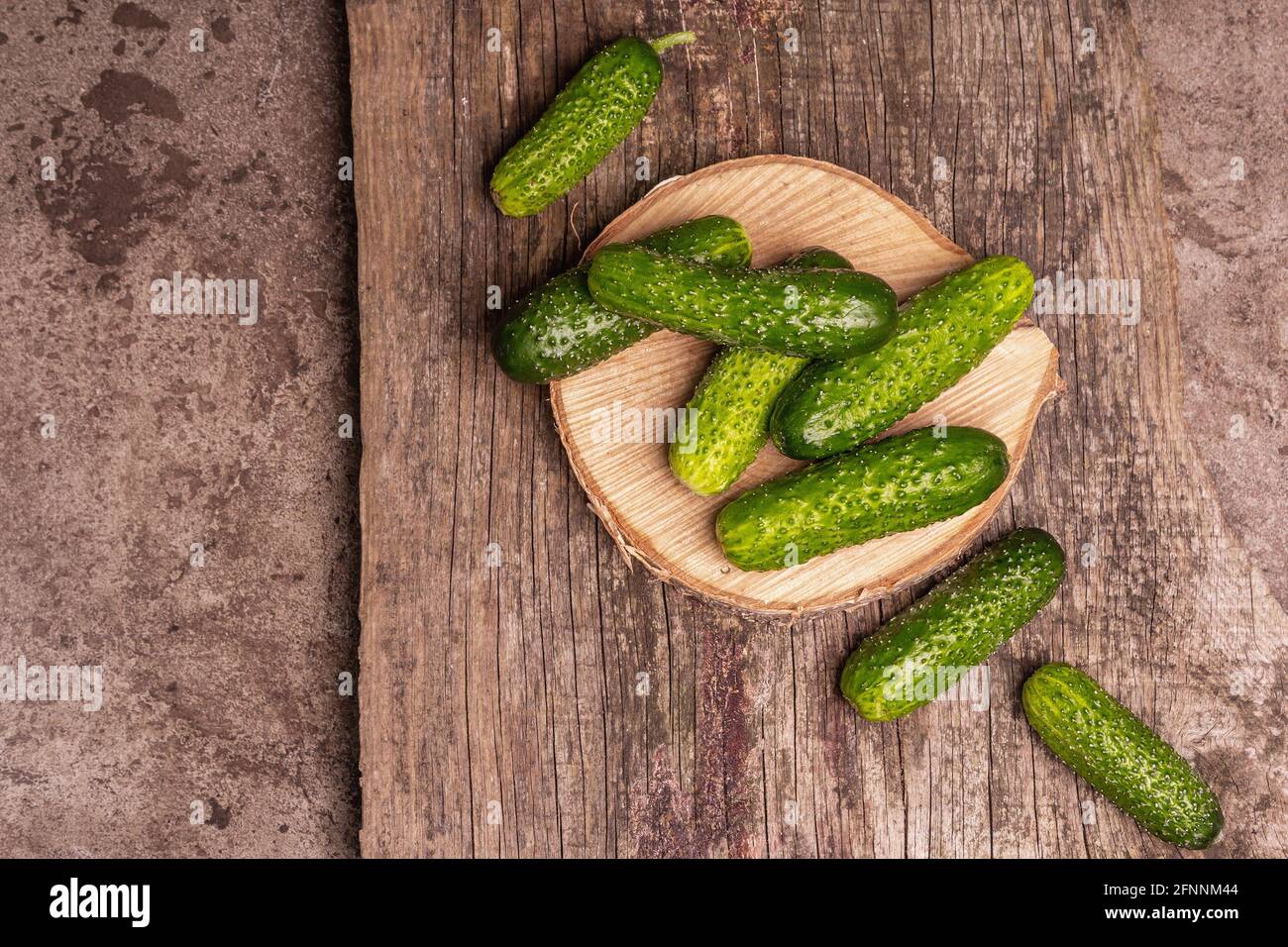 Crispy cucumbers on a wooden stand. Fresh green vegetables, organic ...