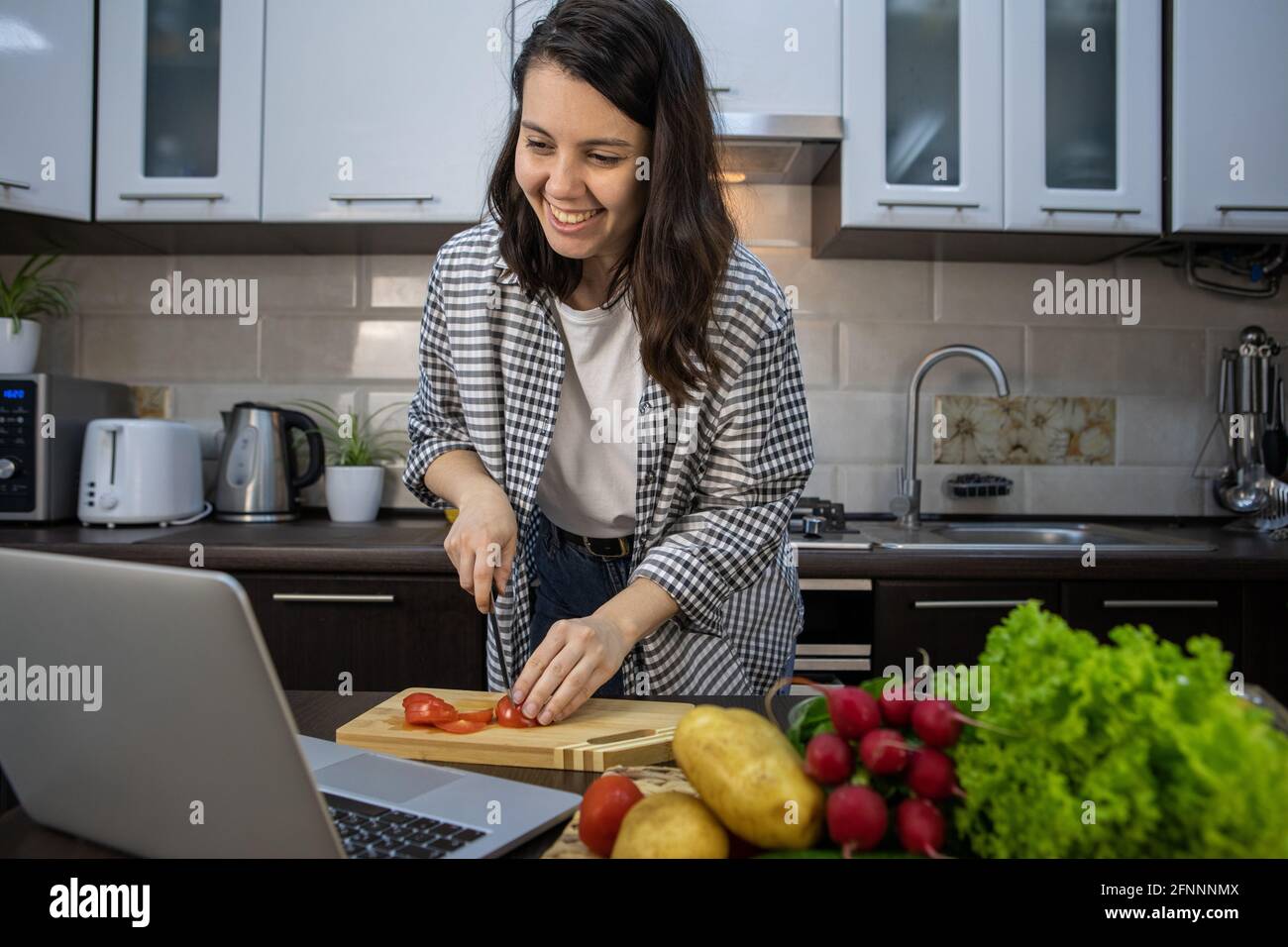 woman cooking checking recipe at laptop copy space Stock Photo - Alamy
