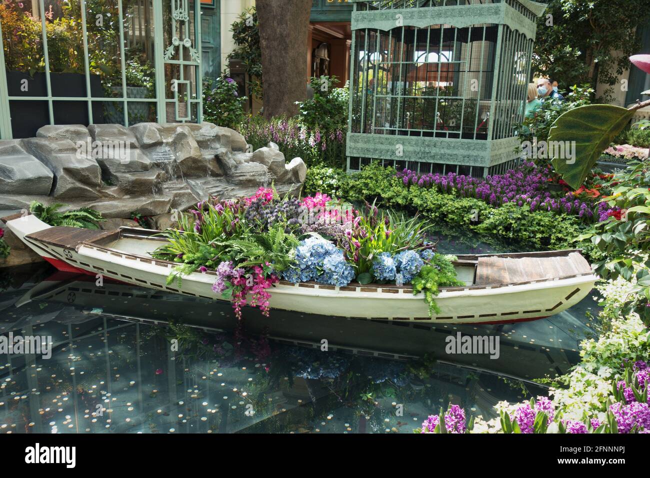 A flower arrangement in a canoe at the Bellagio Conservatory and ...