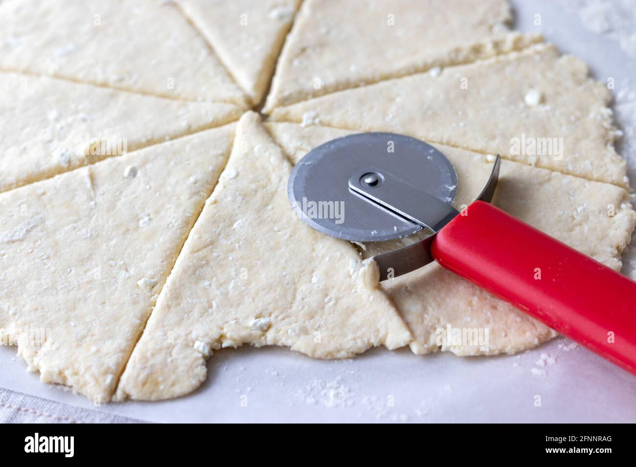 Rolled raw curd dough with bits of cottage cheese cut into eight ...